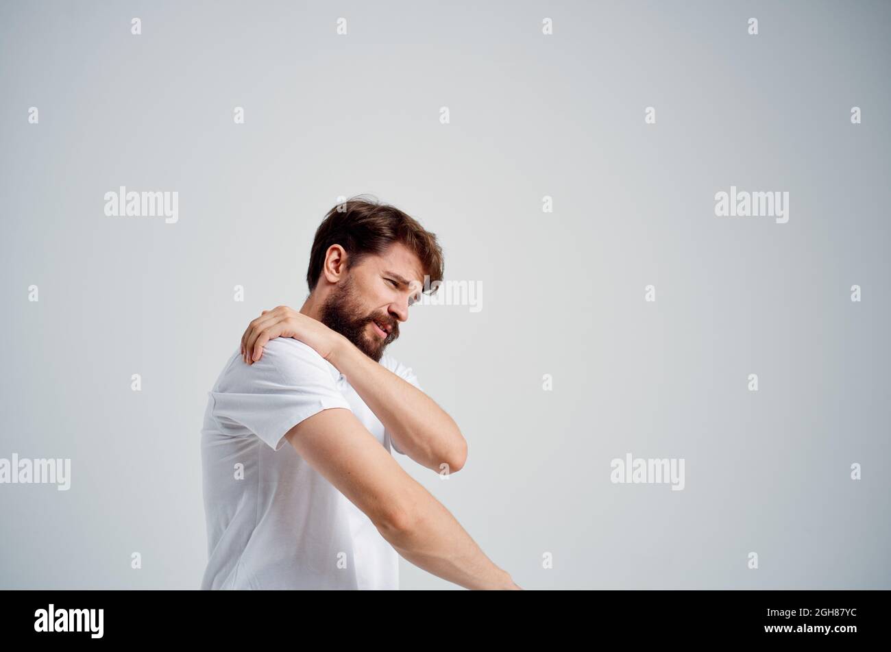 man holding neck arthritis health problems light background Stock Photo ...
