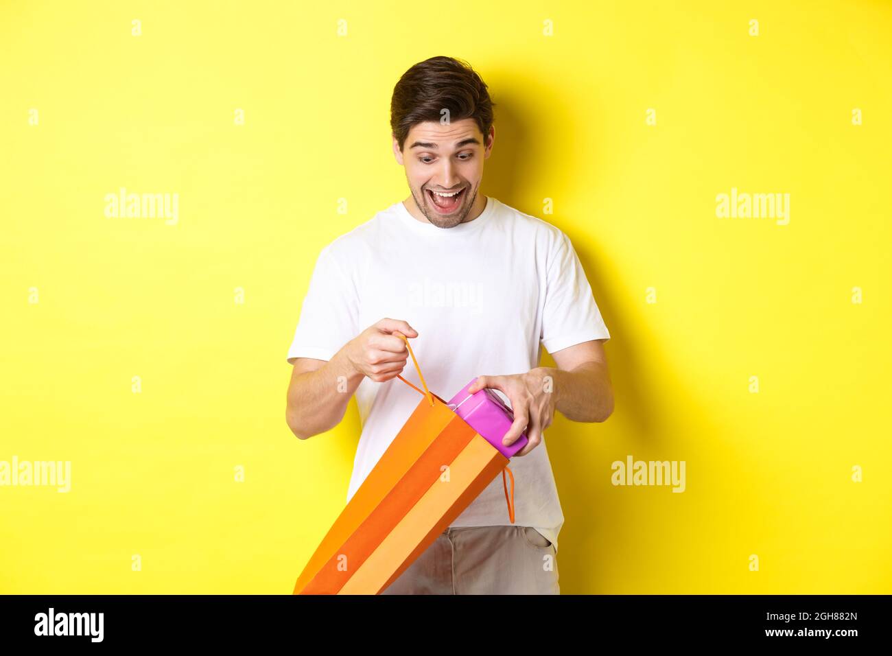 Concept of holidays and celebration. Young man looking surprised as ...