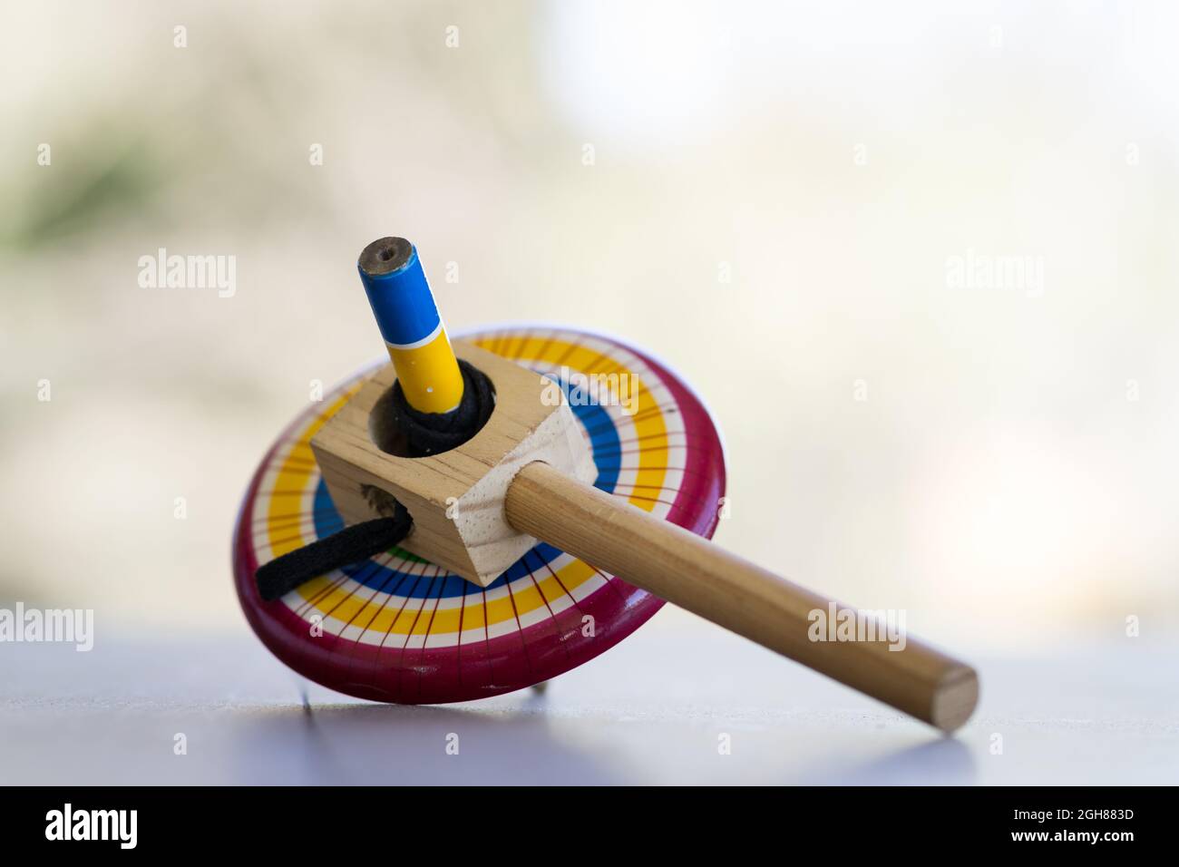 Colorful wooden peg-top or a teetotum on a blurred background Stock ...