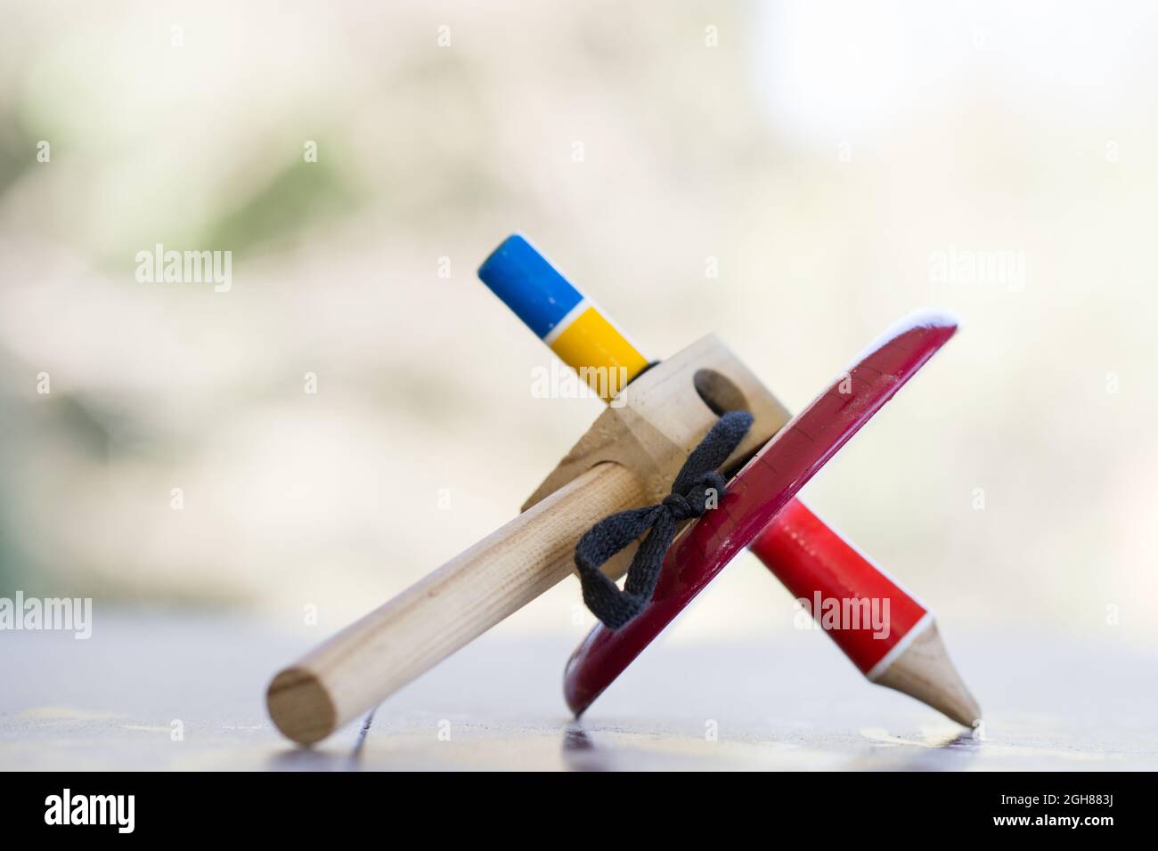 Colorful wooden peg-top or a teetotum on a blurred background Stock ...