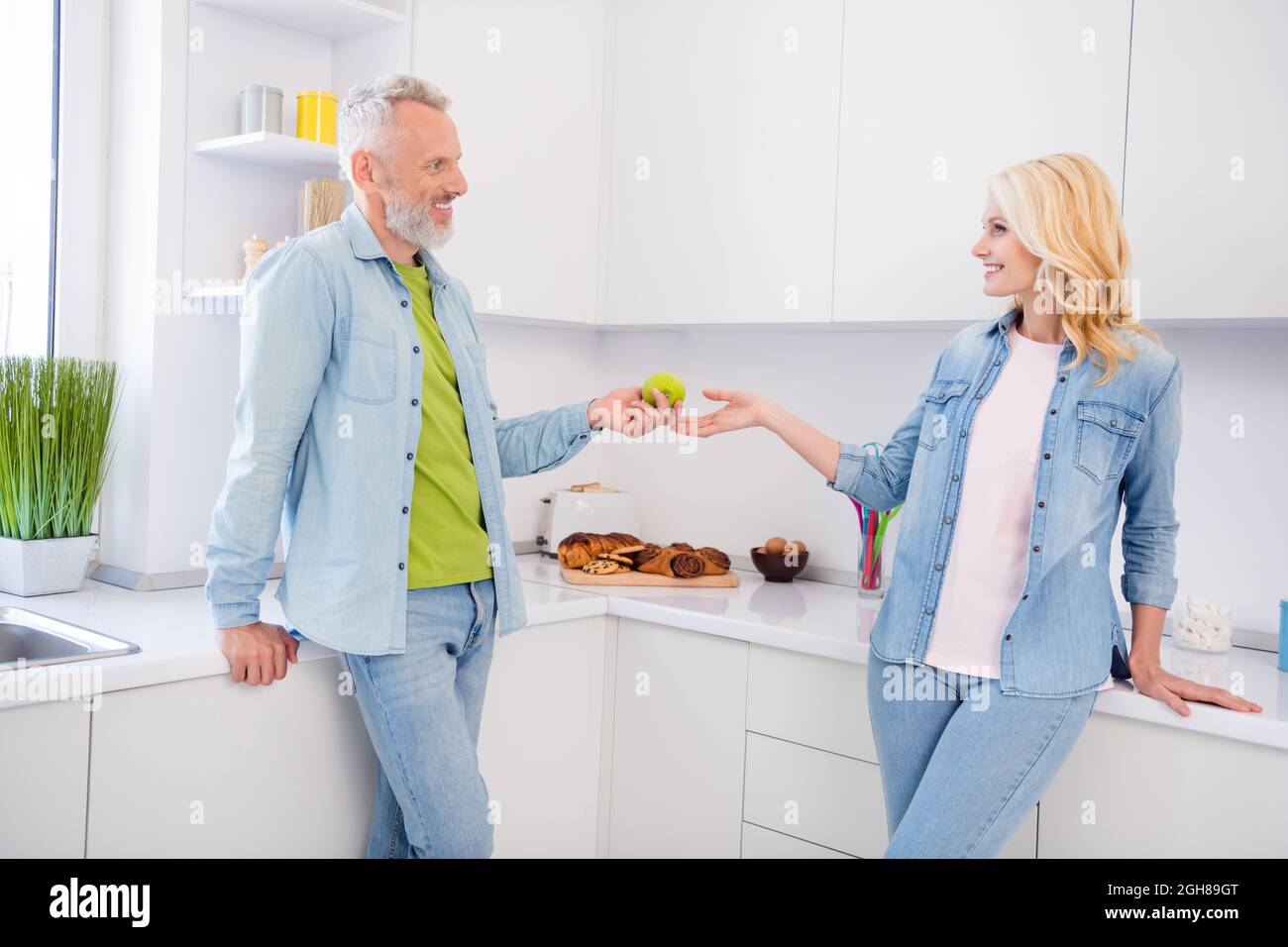 Photo of two people married couple spouses husband give wife apple ...