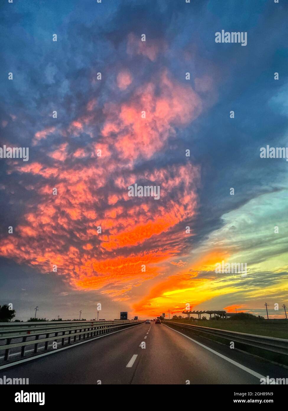 Suggestive red sunset of late summer on an Italian highway Stock Photo ...