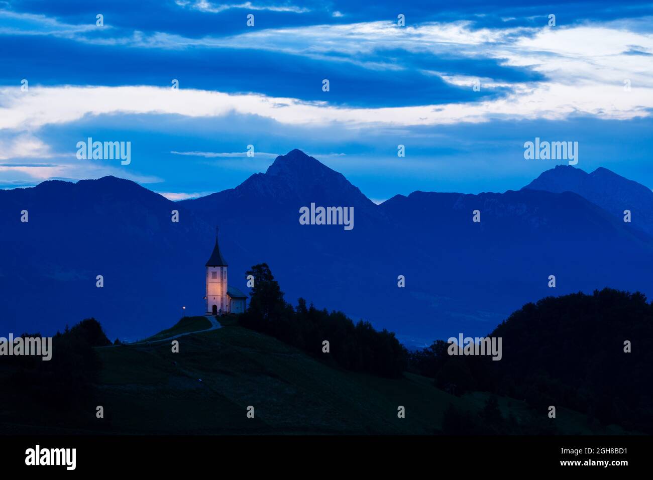 Jamnik church of Saints Primus and Felician at dawn, perched on a hill ...