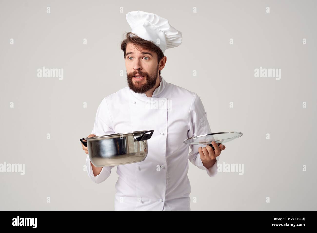 male chef with a saucepan in his hands cooking food service work Stock ...