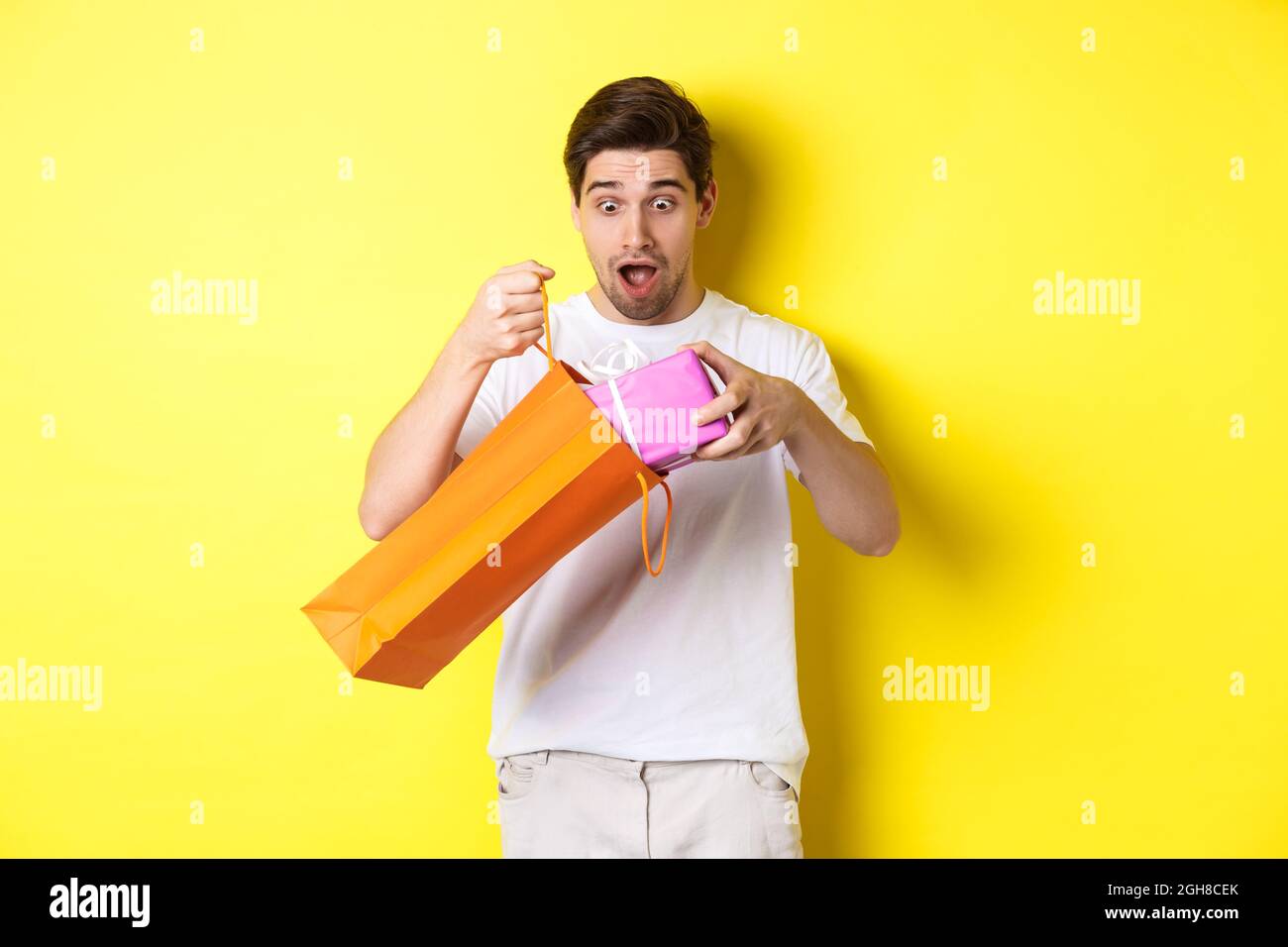Concept of holidays and celebration. Young man looking surprised as ...