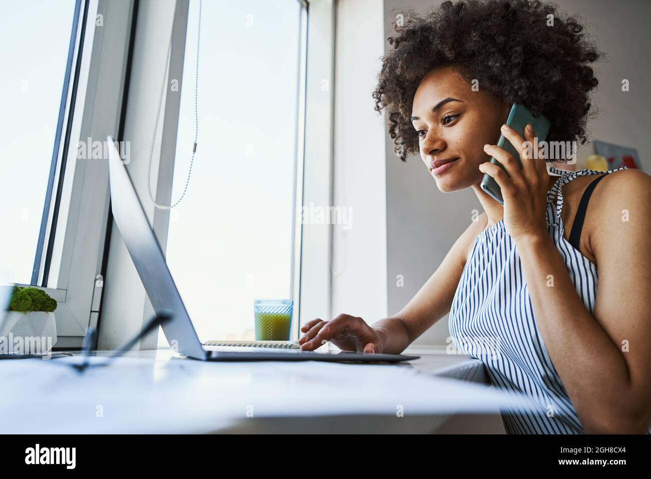 Female freelancer concentrated on writing an email Stock Photo - Alamy