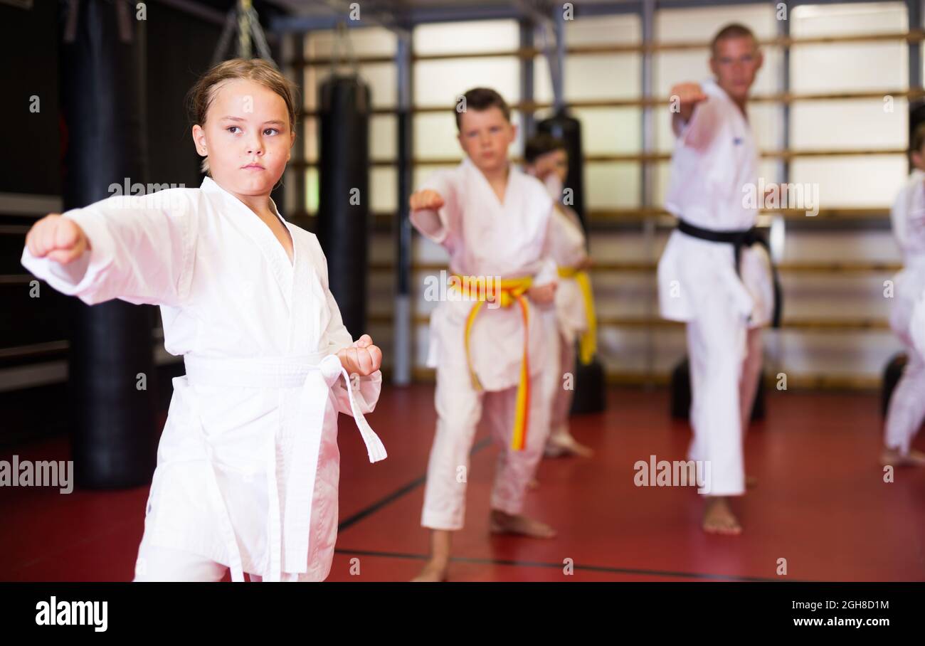 Girl fighting karate stand in the gym. Children in a pair practice ...