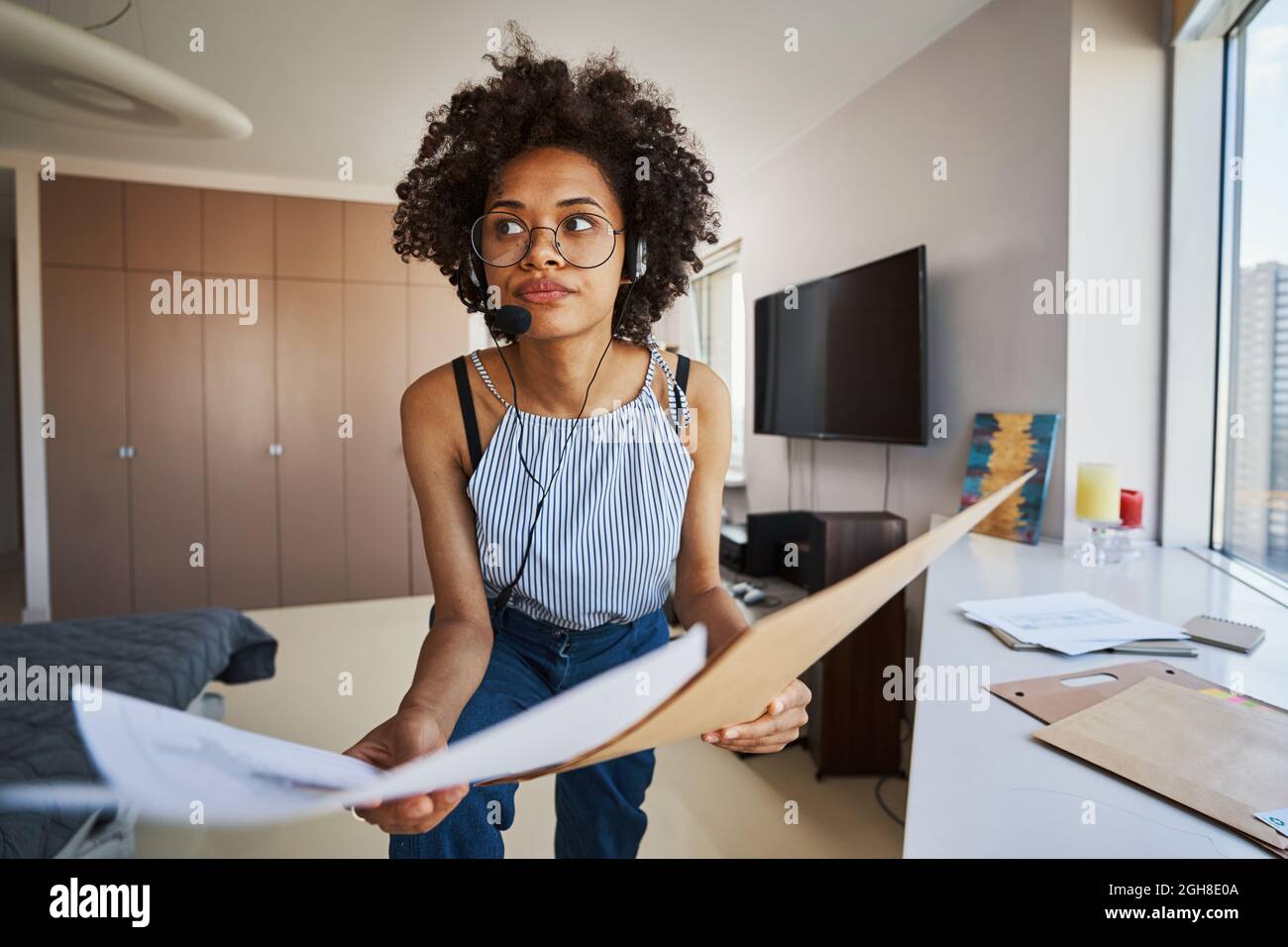 Draftswoman with technical drawings in her hands looking away Stock ...