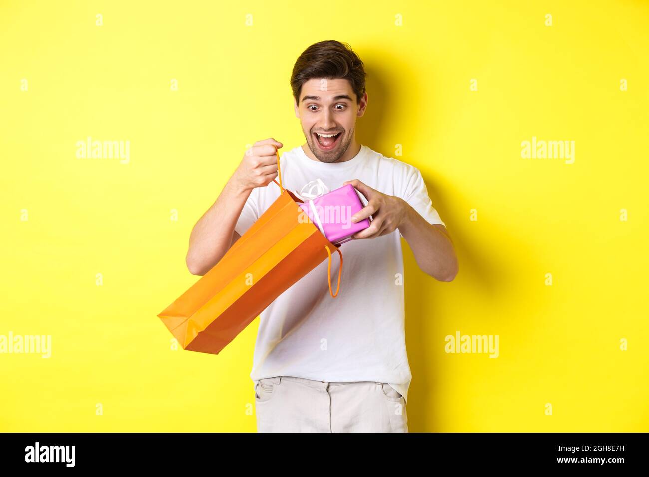 Concept of holidays and celebration. Young man looking surprised as ...