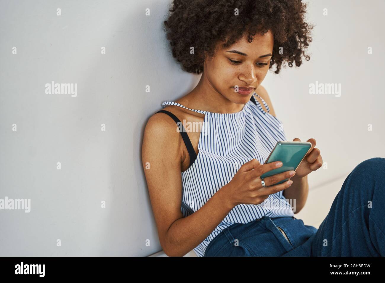 Focused pretty lady staring at her smartphone Stock Photo - Alamy