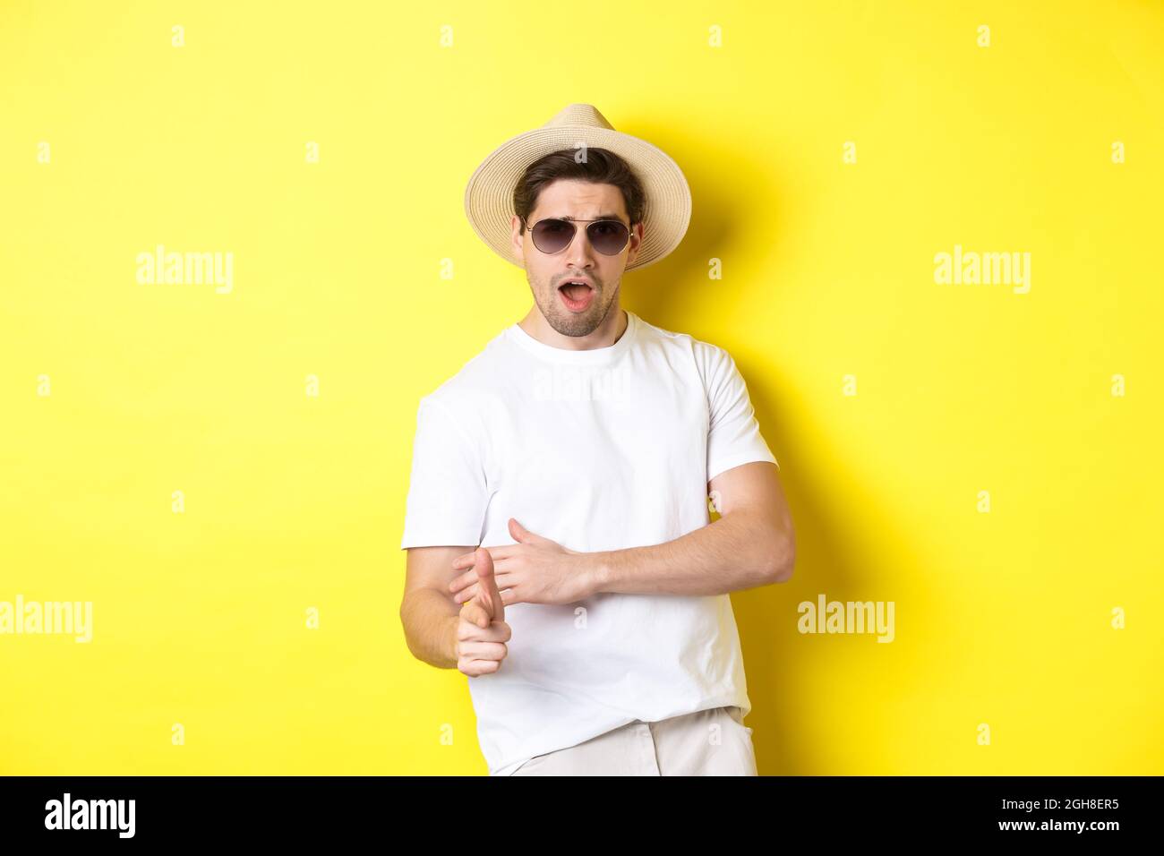 Handsome guy making finger gun shot and looking sassy, dressed for ...