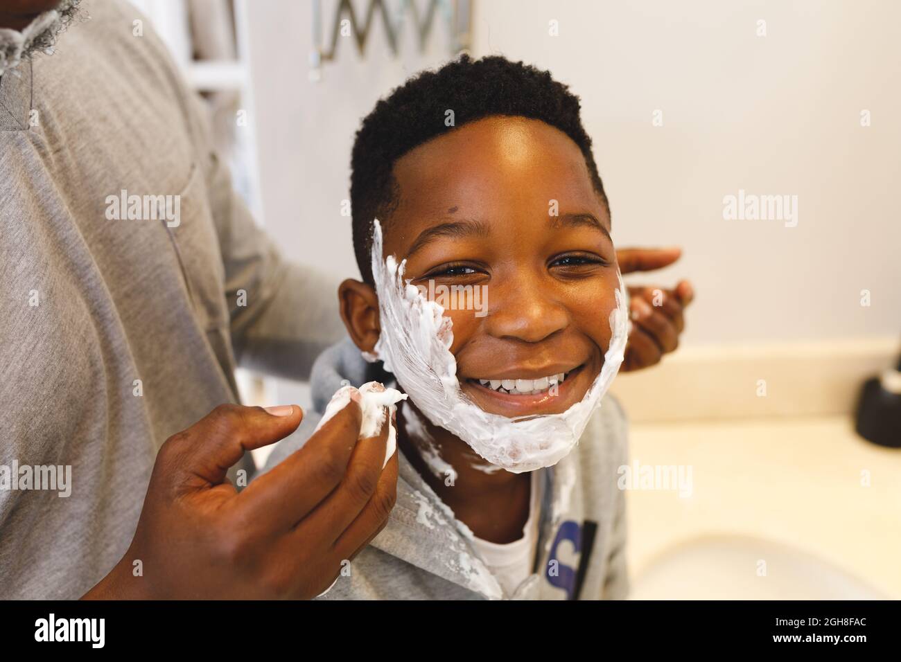 Portrait Of African American Son Having Fun With Father And Shaving
