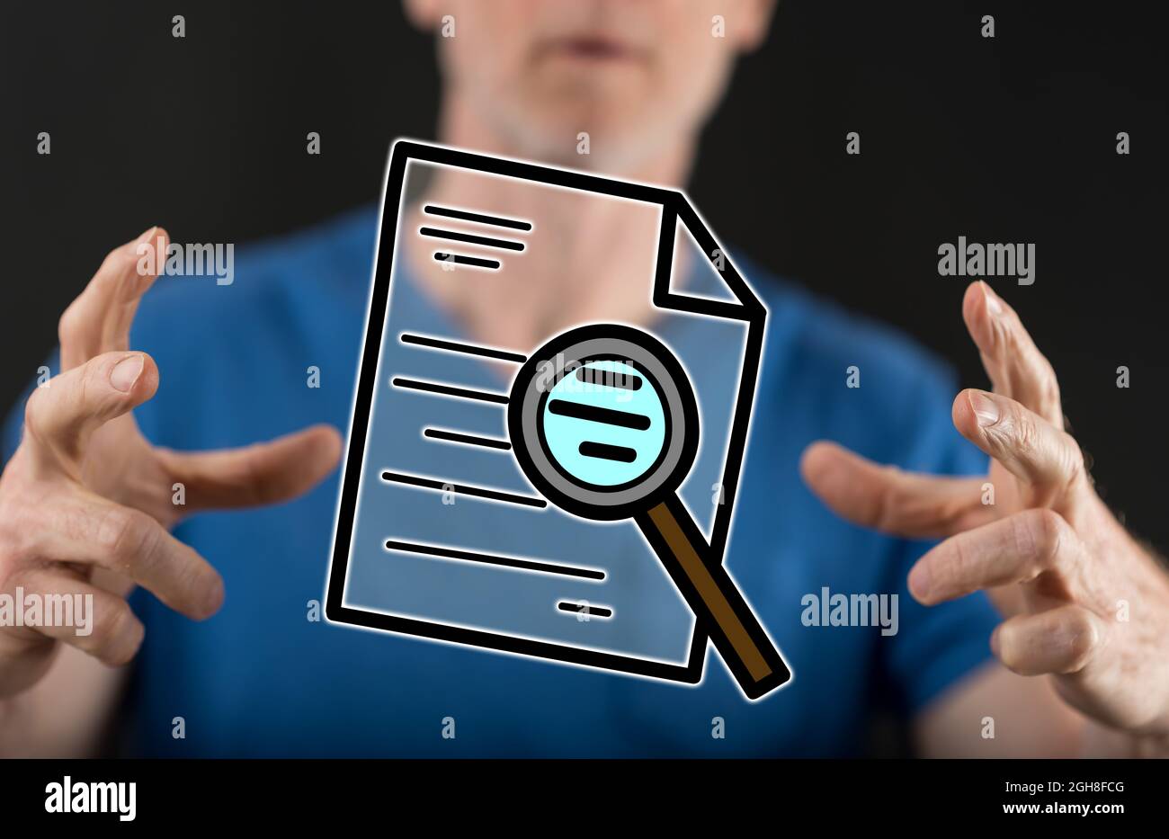 Audit concept between hands of a man in background Stock Photo - Alamy