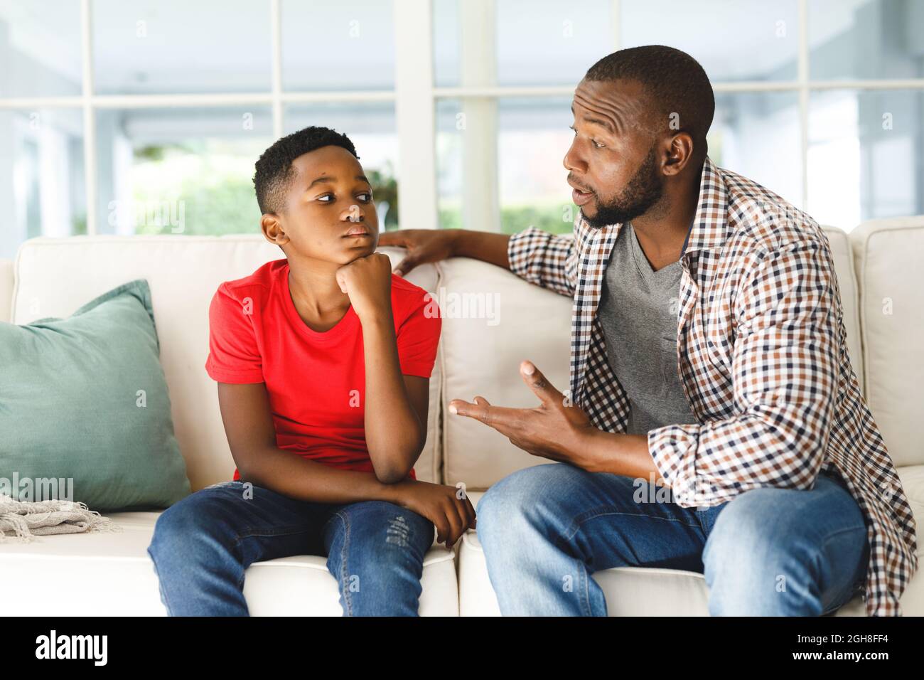 Father son sitting together couch living room hi-res stock photography ...