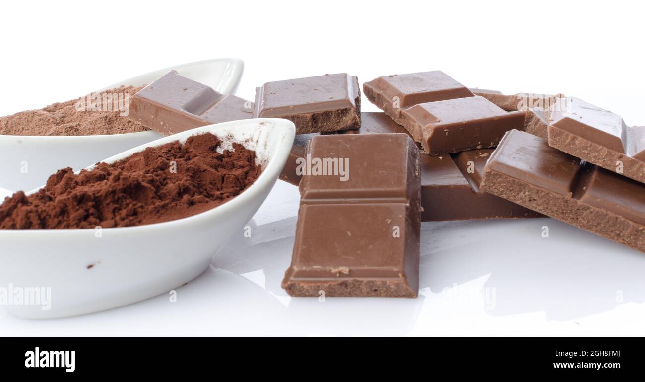 Chocolate squares and cocoa powder, isolated on white Stock Photo - Alamy
