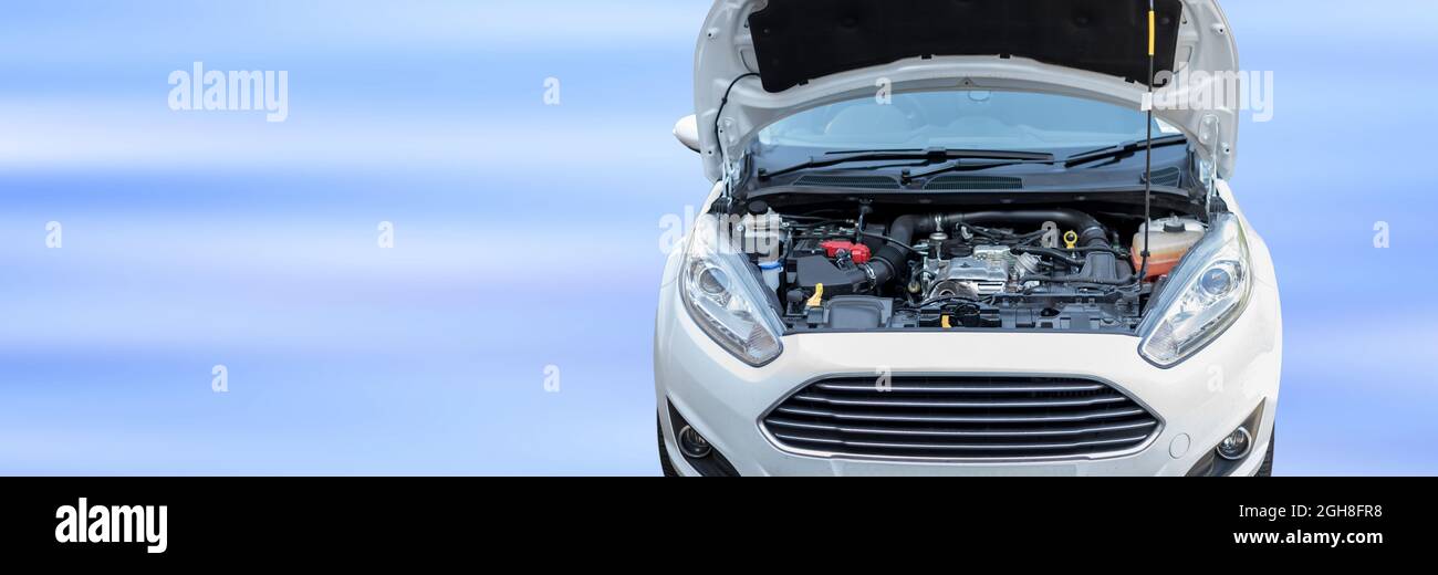 Front of new white car with open motor hood on blurred background Stock ...