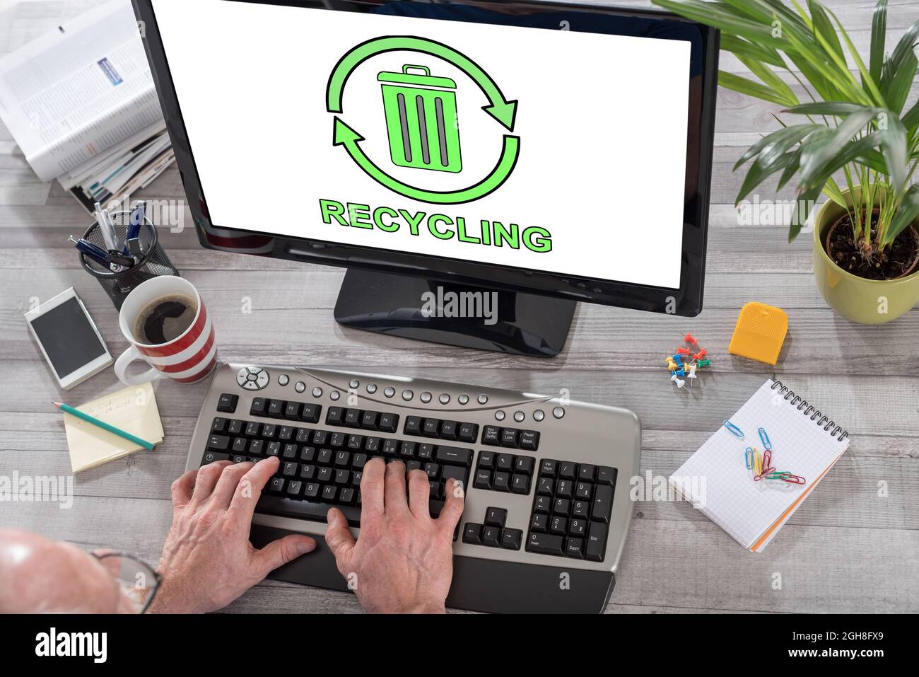 Man using a computer with recycling concept on the screen Stock Photo ...