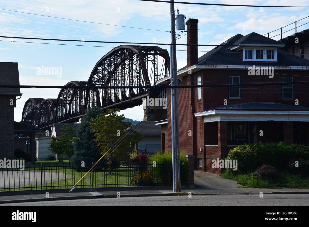 The railroad bridge cuts through a residential neighborhood in the town ...