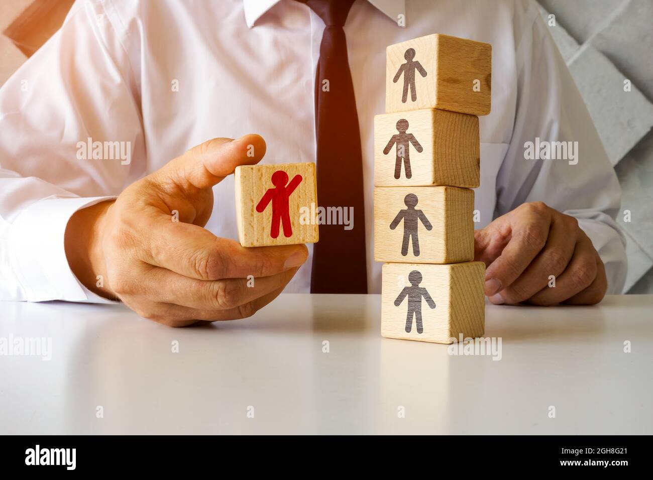 Talent management concept. Cubes with figures and red figure of leader ...