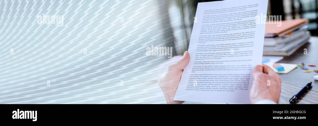 Checking a document in office. panoramic banner Stock Photo - Alamy