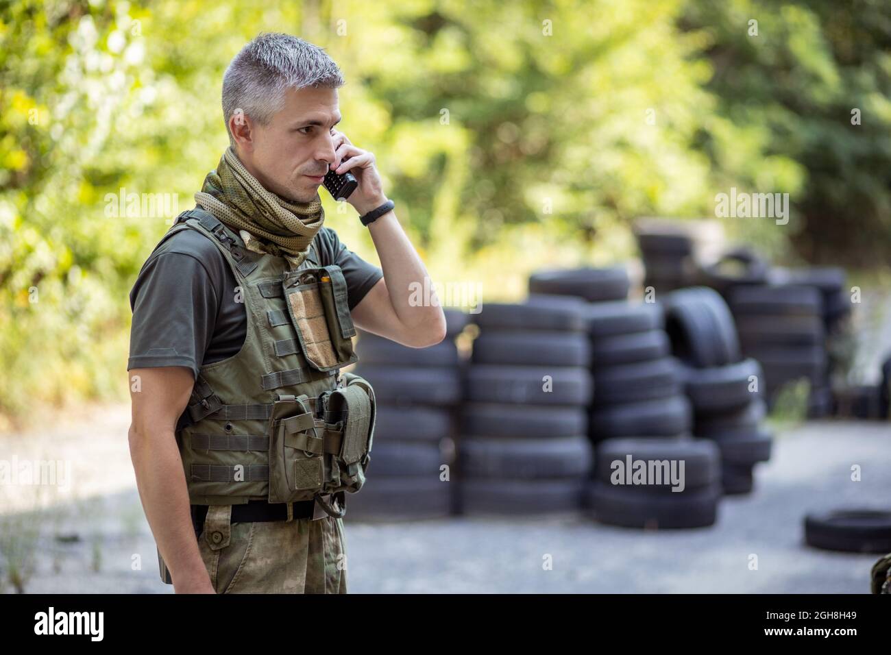 A man talking on the radio in military uniform Stock Photo - Alamy
