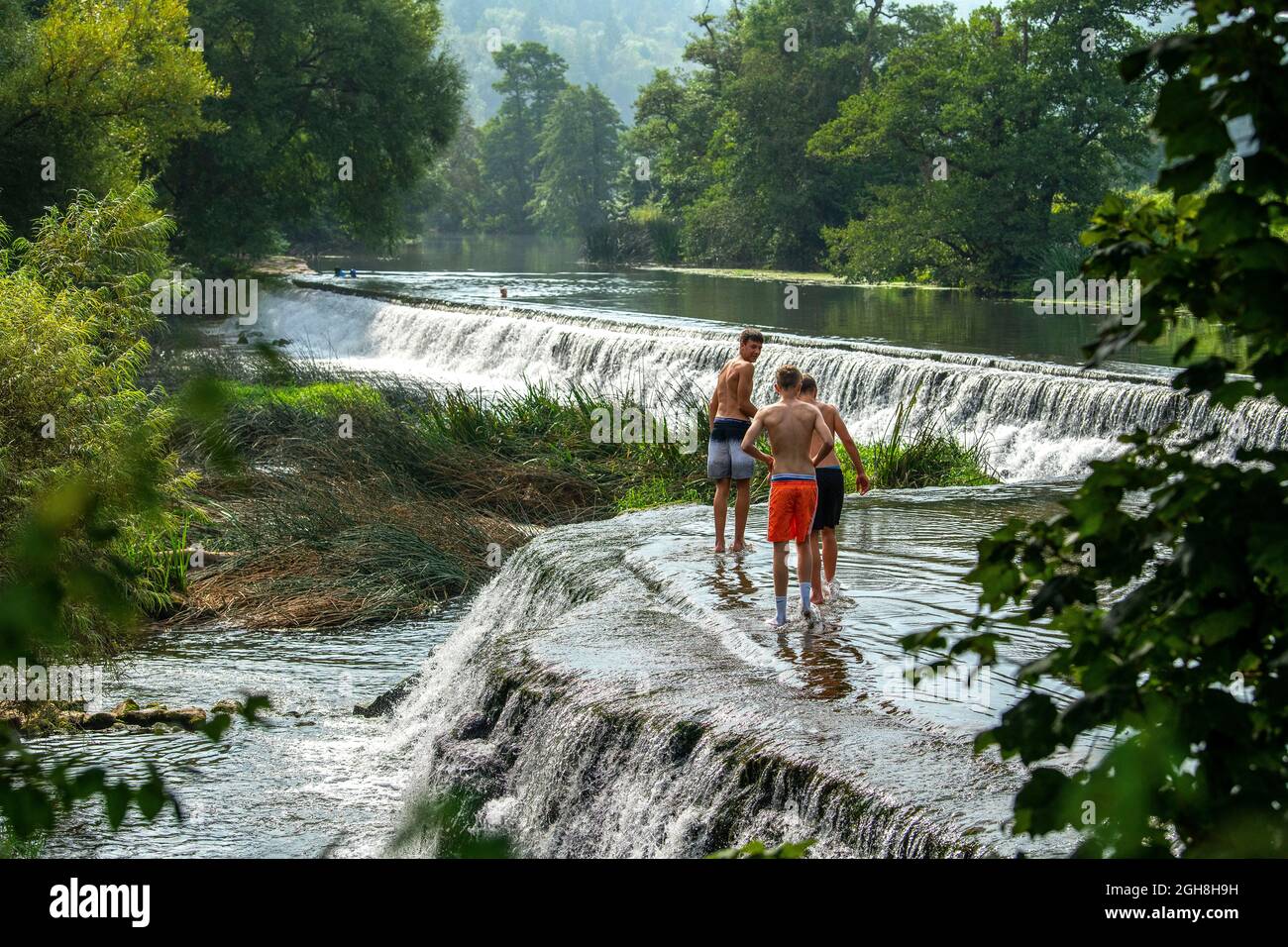 People enjoy the water at Warleigh Weir on the River Avon near Bath in ...