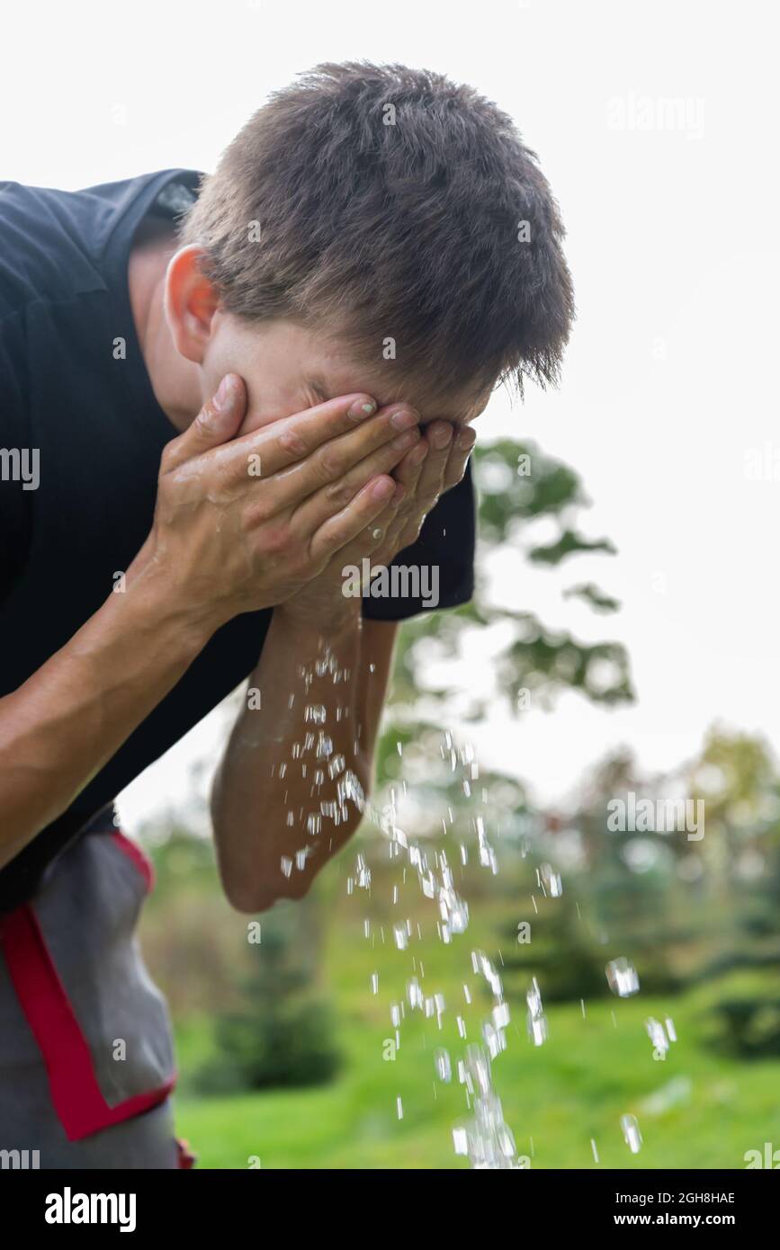 Man washing face hi-res stock photography and images - Alamy