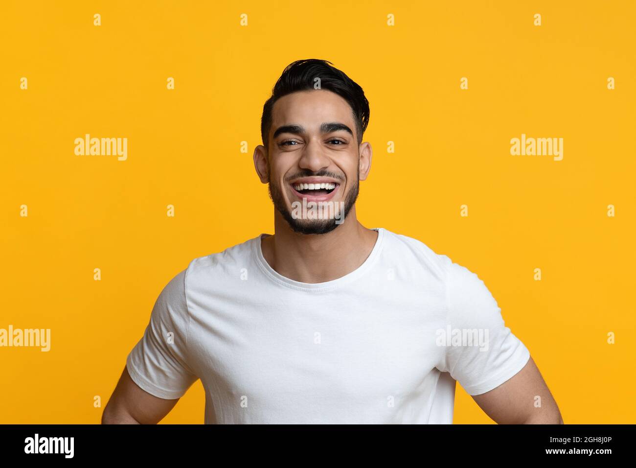 Closeup portrait of cheerful arab guy laughing at camera Stock Photo ...