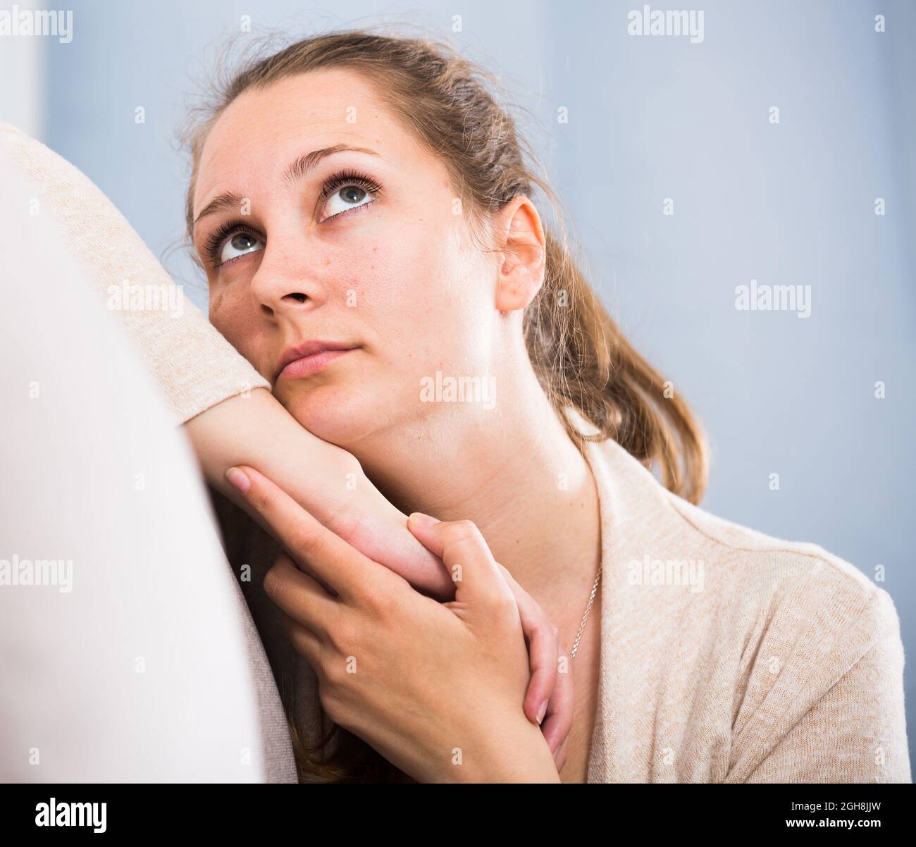 Young woman feeling distressed and lonely alone at home Stock Photo - Alamy