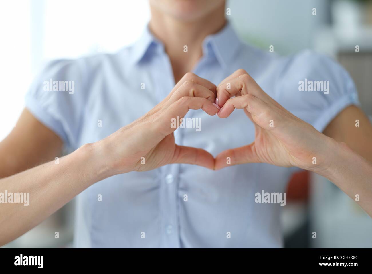 Woman shows heart hand gesture of love closeup Stock Photo - Alamy