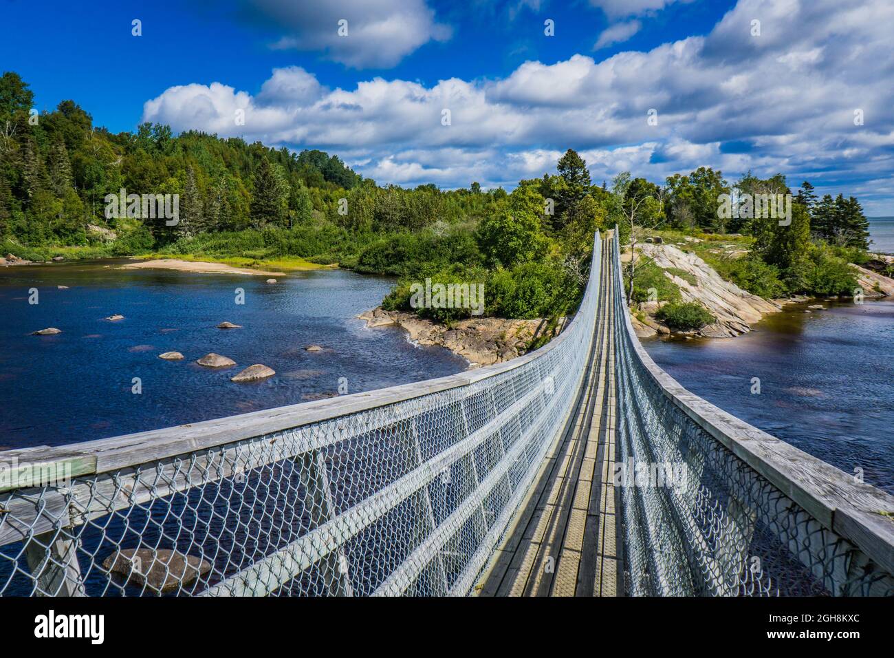 Footbridge over the Sault Au Mouton waterfall in Cote Nord, Quebec ...