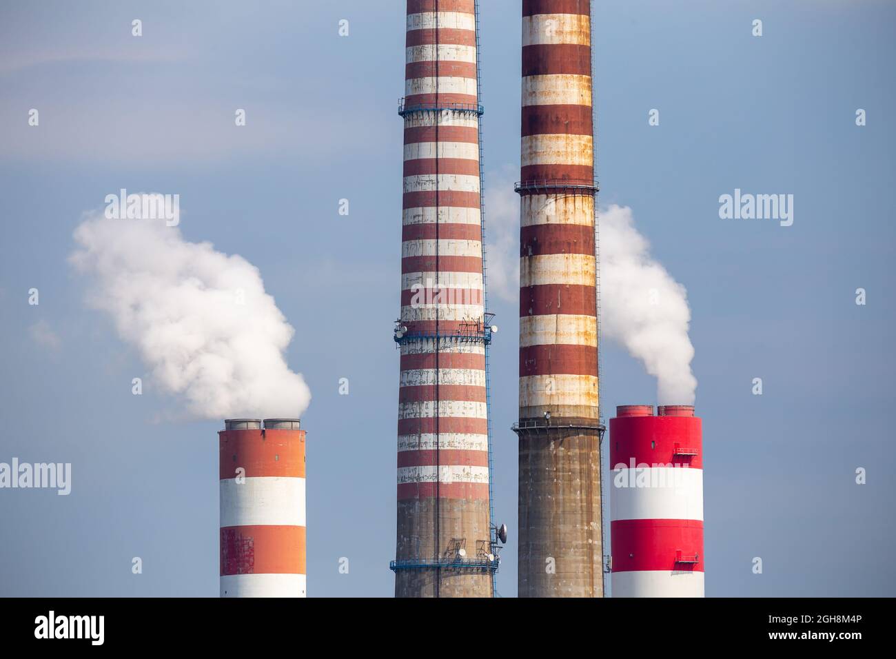 A close-up of the smoking stacks of a coal-fired power plant. Photo ...