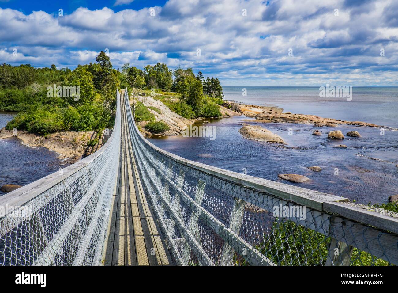 Footbridge over the Sault Au Mouton waterfall in Cote Nord, Quebec ...