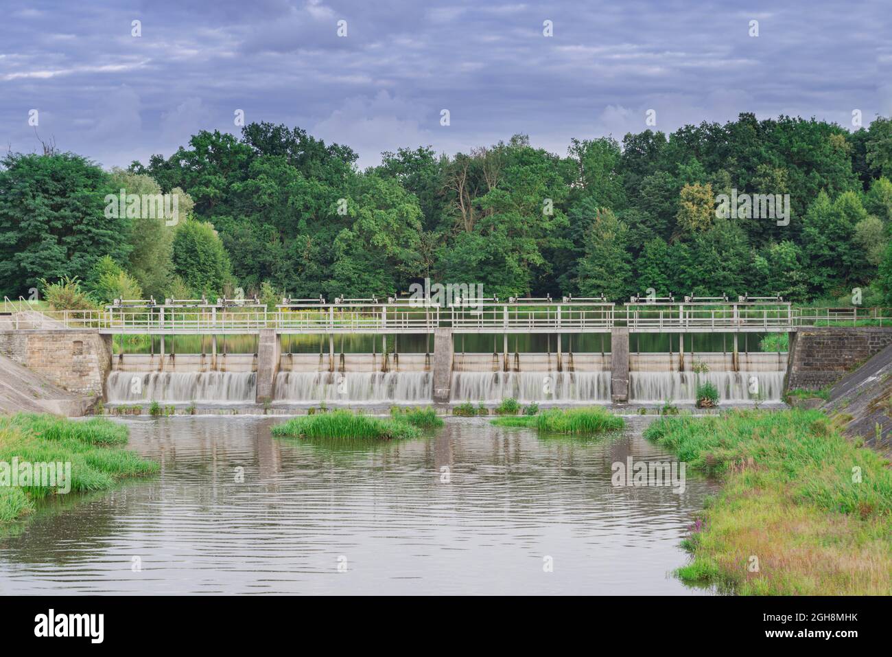 A dam regulating the water level on the river Stock Photo - Alamy