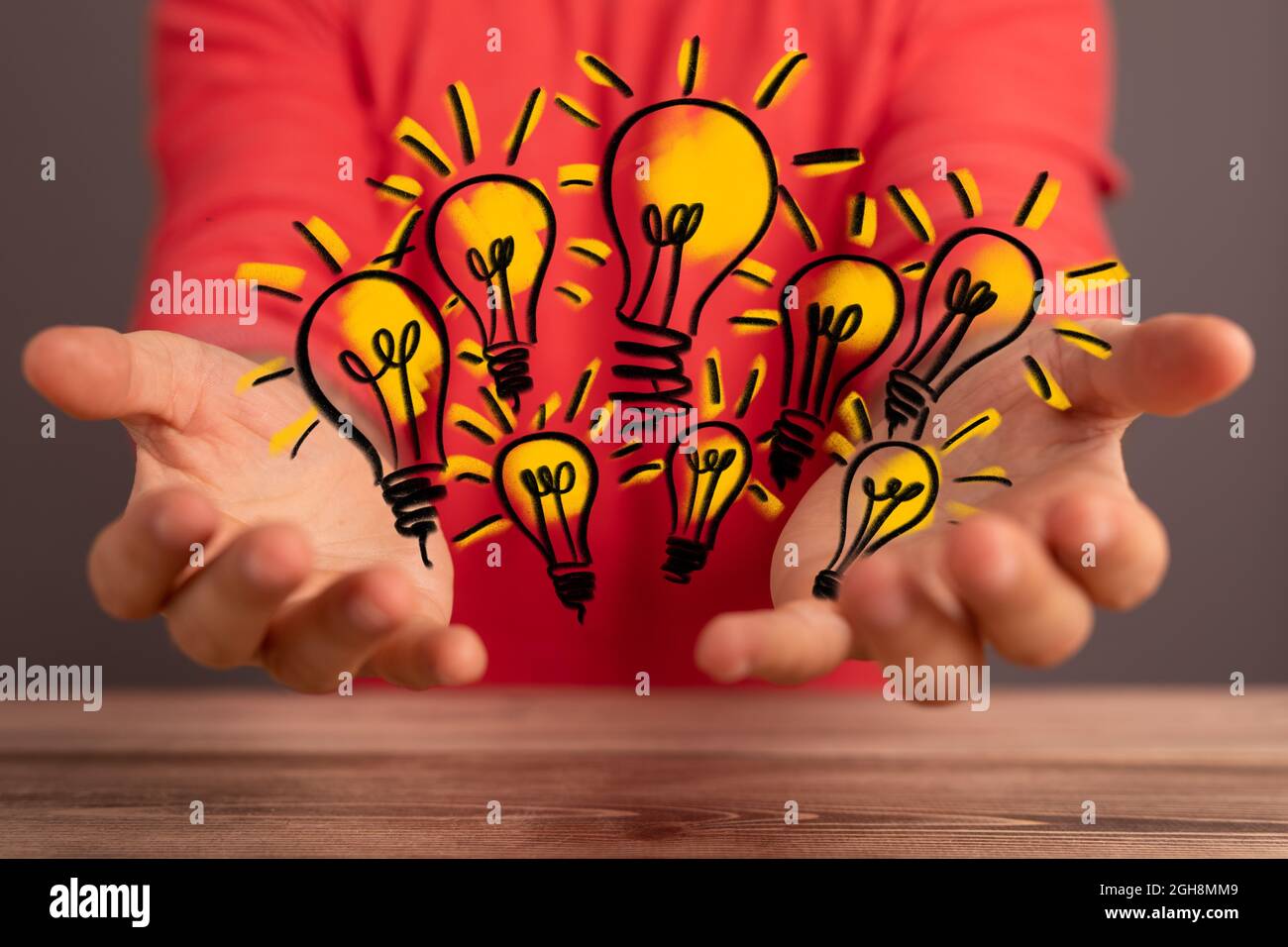 Group of illustrated light bulbs in man hands as a solution and idea ...