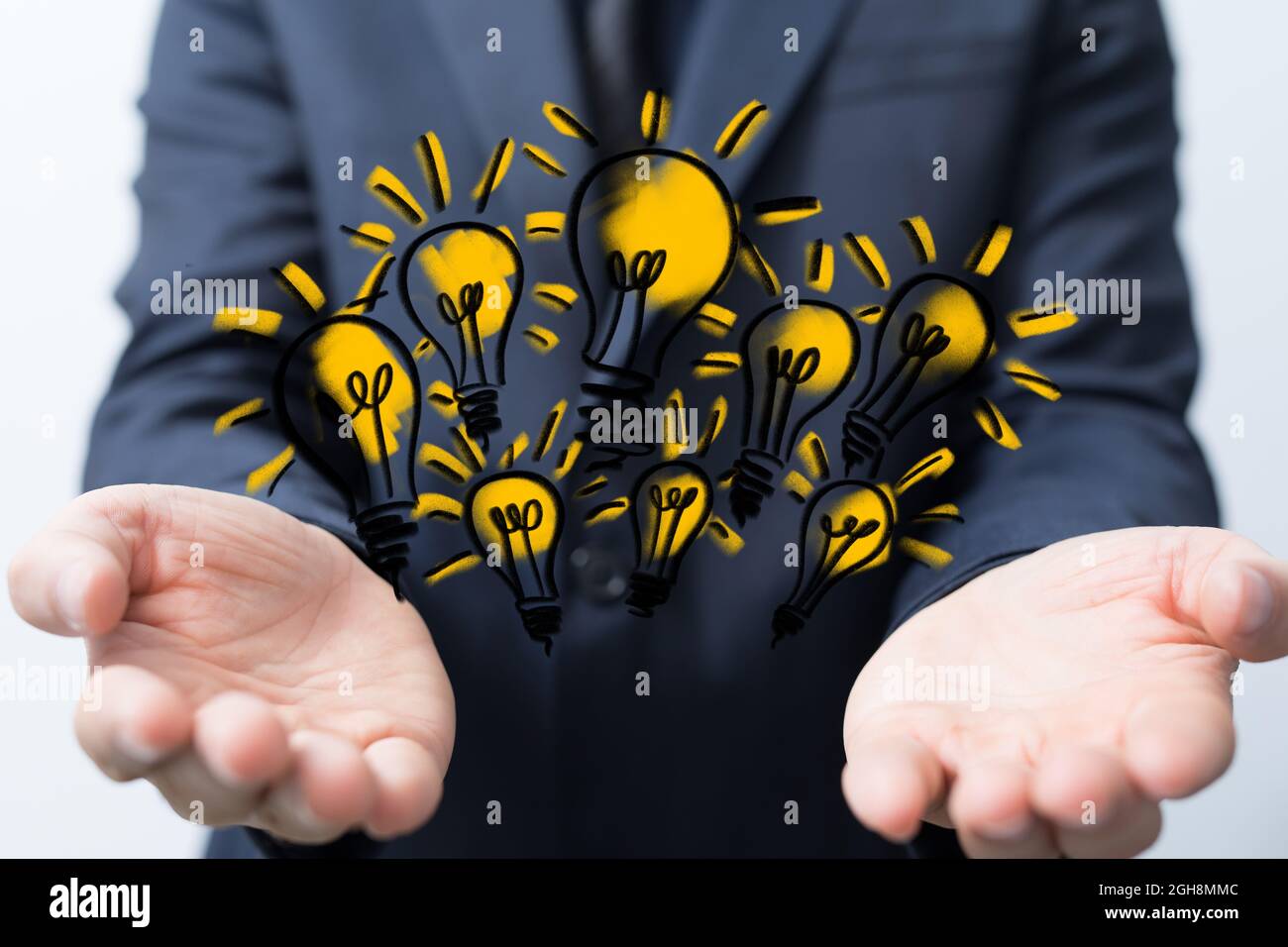 Group of illustrated light bulbs in man hands as a solution and idea ...