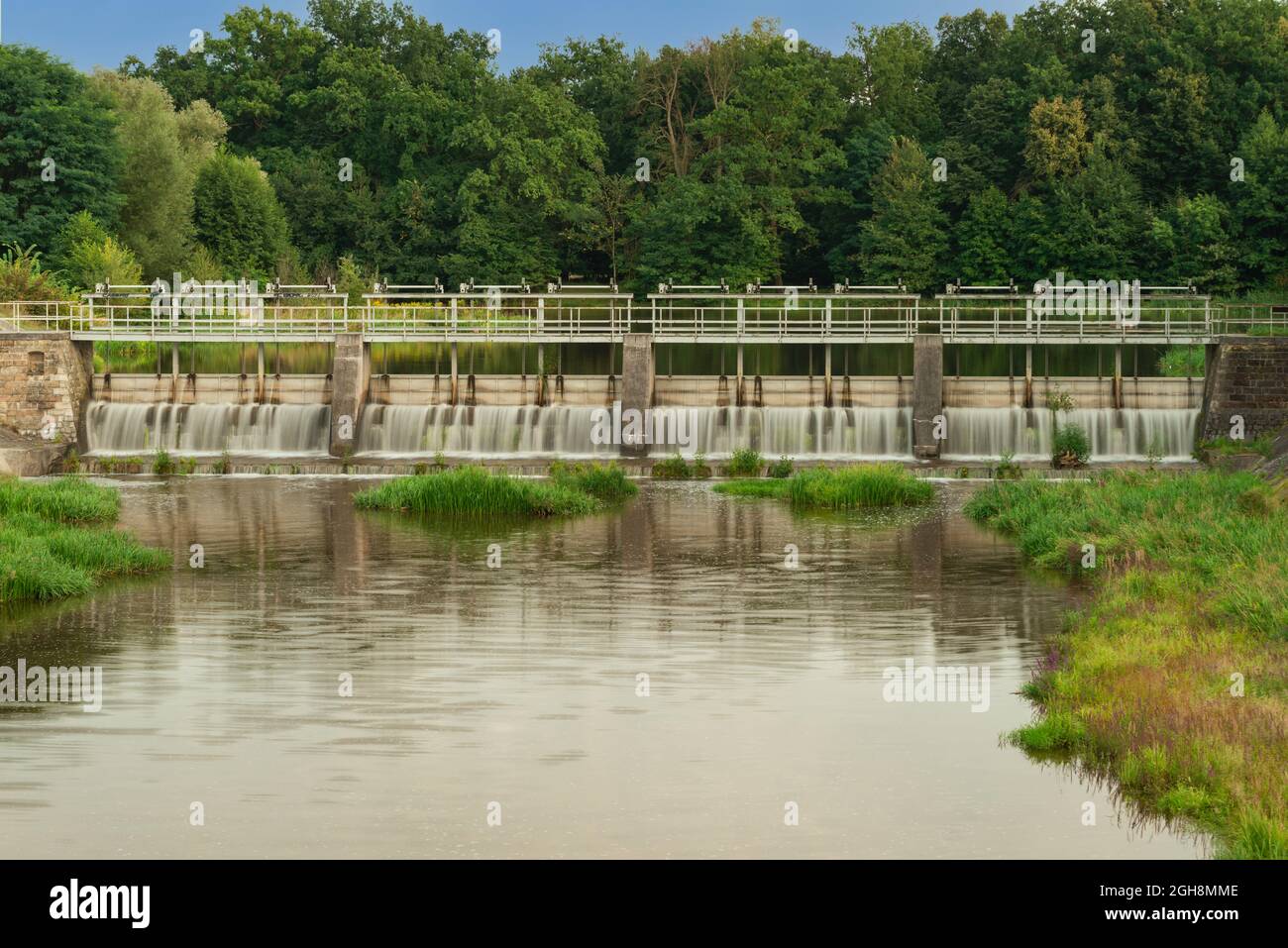 A dam regulating the water level on the river Stock Photo - Alamy