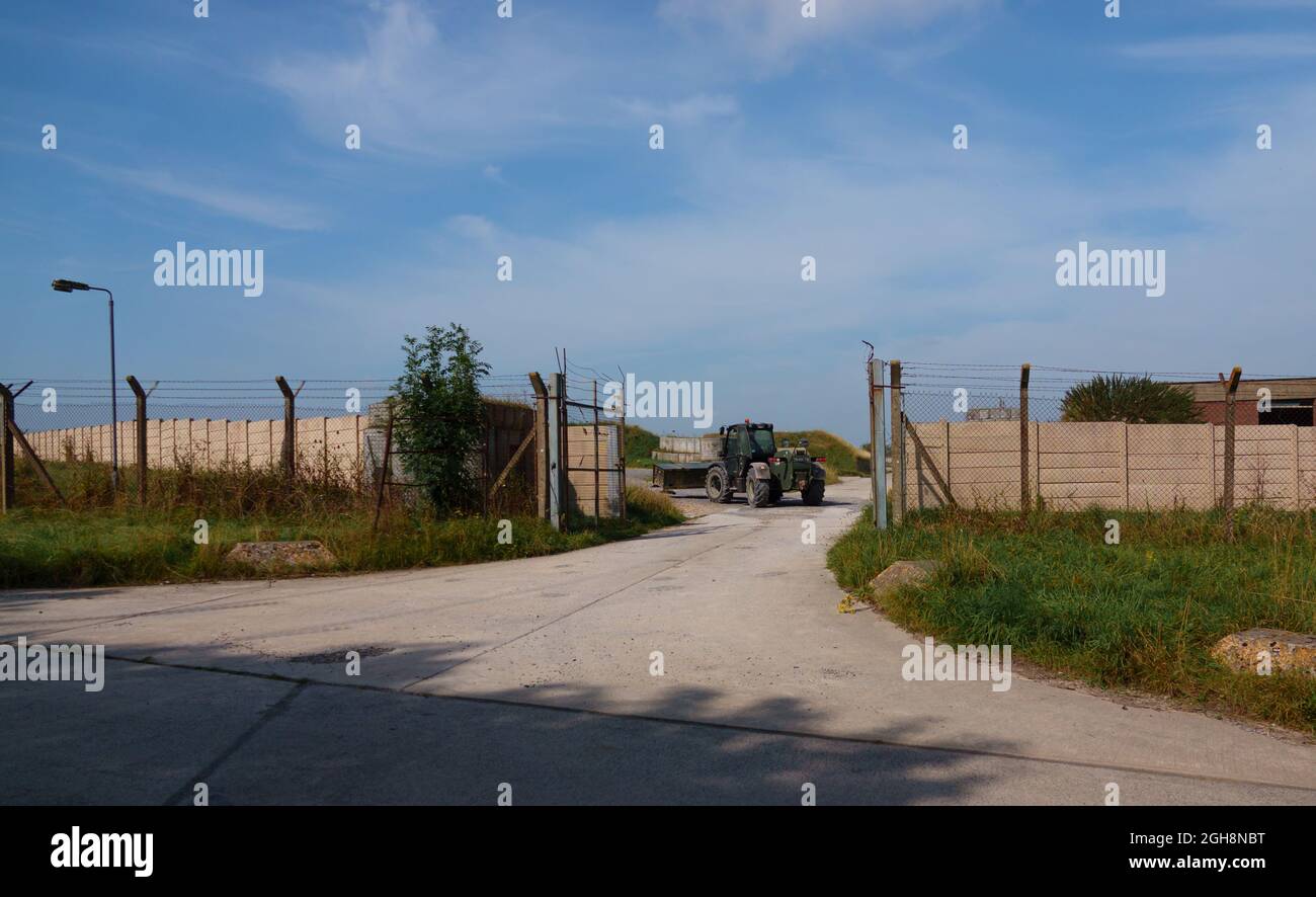 British army JCB fork lift truck moving boxed weapons in preparation ...