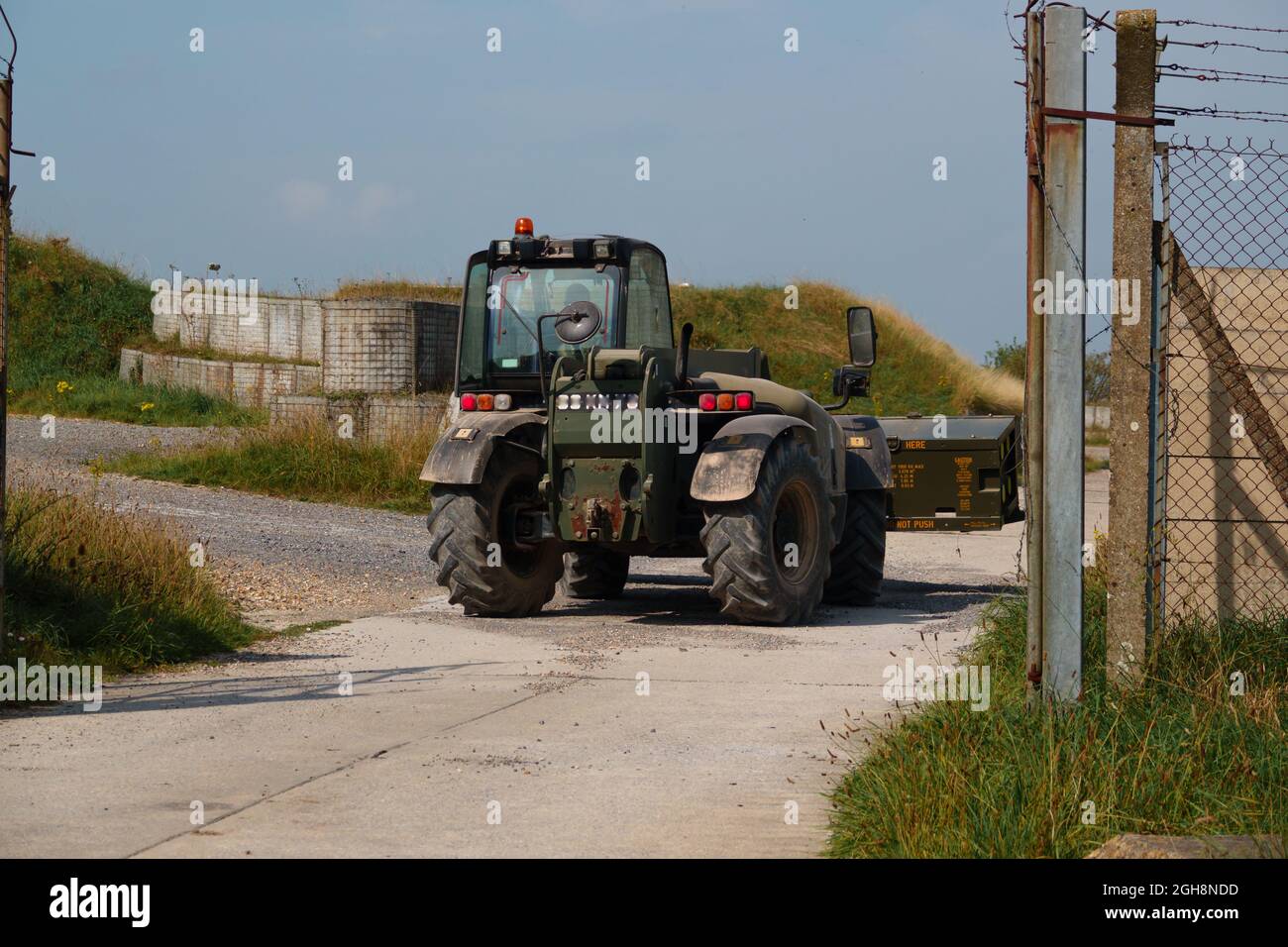 British army JCB fork lift truck moving boxed weapons in preparation ...