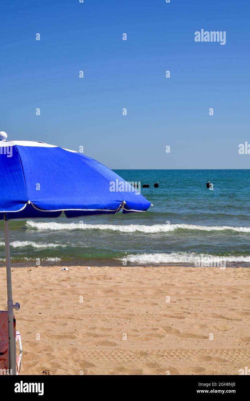 colorful umbrella against blue summer sky along the beach Stock Photo ...