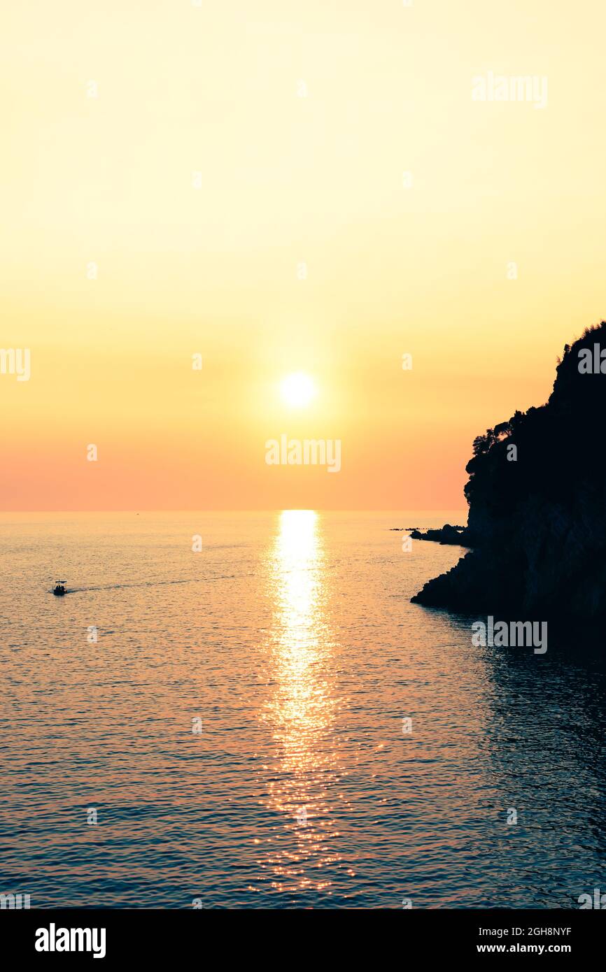 Beautiful golden Sunset at sea and Boat sailing Stock Photo - Alamy