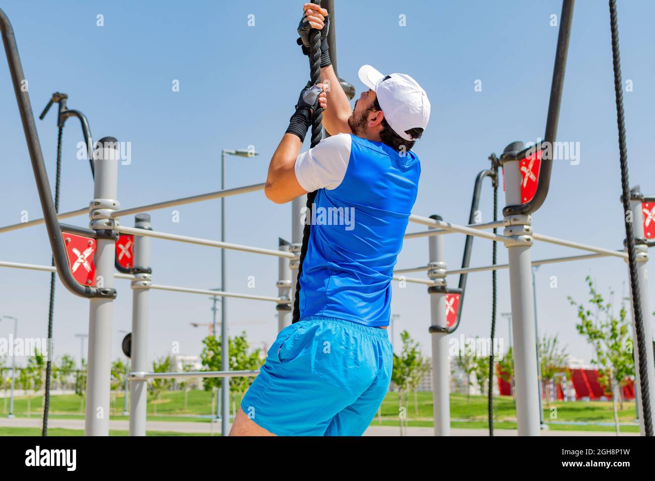 Athlete man climbing rope hi-res stock photography and images - Alamy