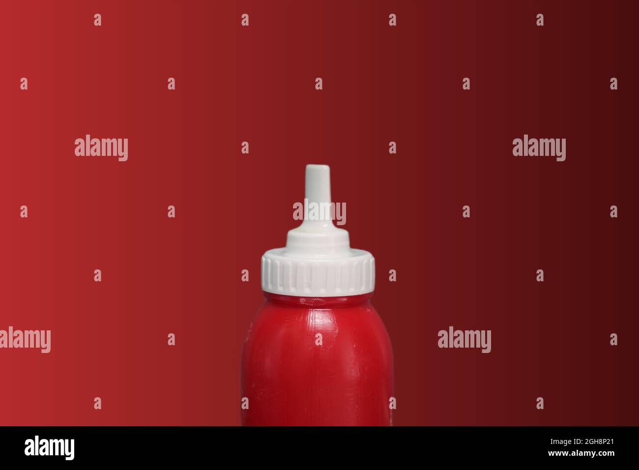 Closeup shot of a red dropper bottle isolated on a red background Stock ...