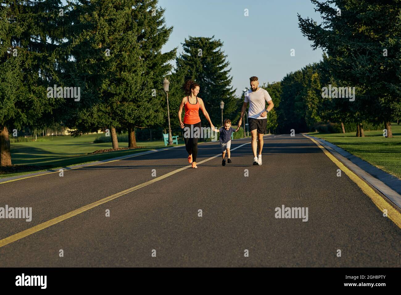 Young family with their child doing morning workout. Healthy lifestyle ...