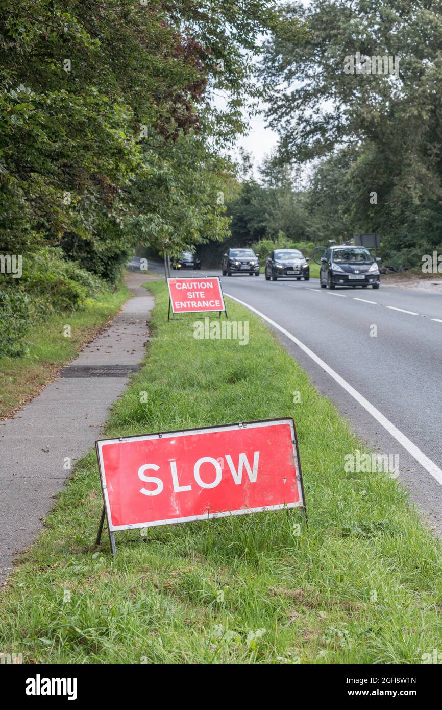 Red SLOW sign on a country 'A road' in Cornwall (focus on Slow). For ...
