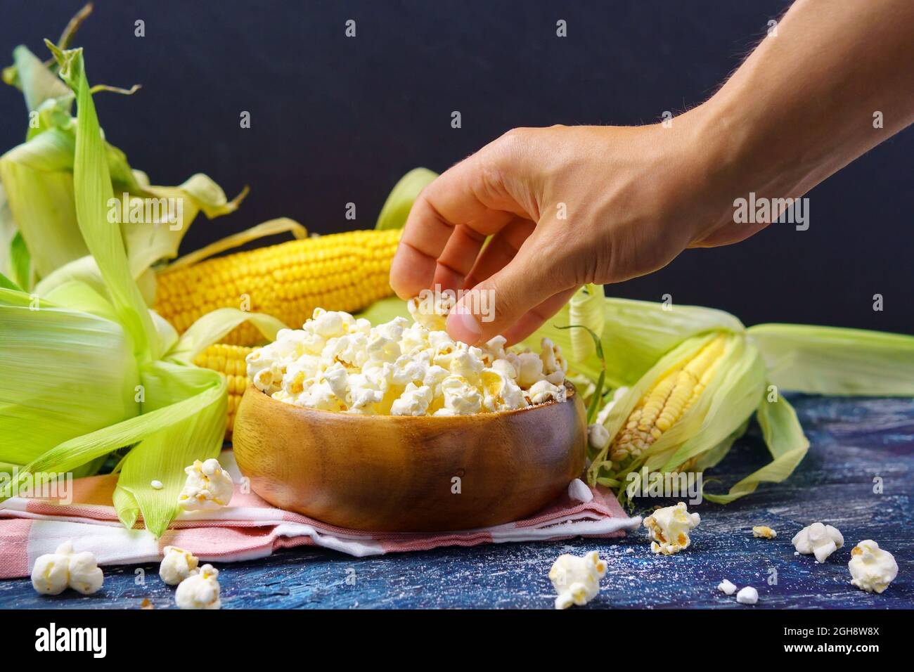 Fresh corn and popcorn on cobs on black background. close up Stock ...