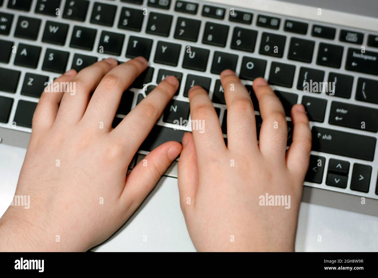 Online education. Kids hands on laptop keyboard. Close-up. Computer ...