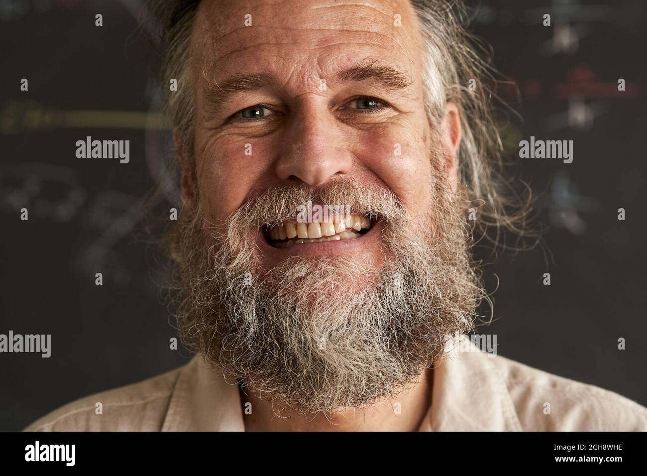 close-up of the face of the smiling middle-aged man looking into the ...
