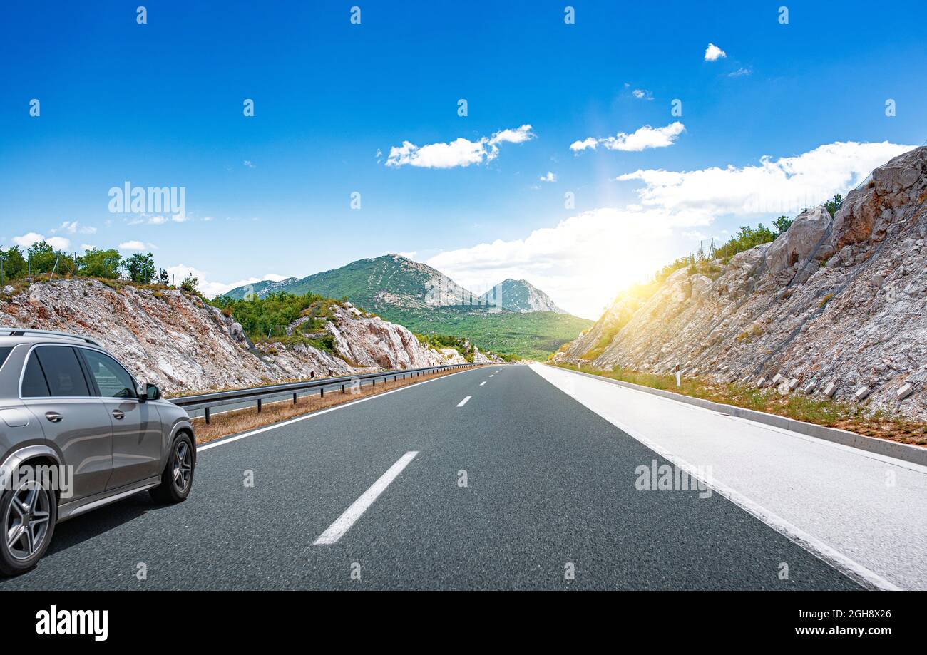 Car is driving along the road. White car on a suburban highway Stock ...