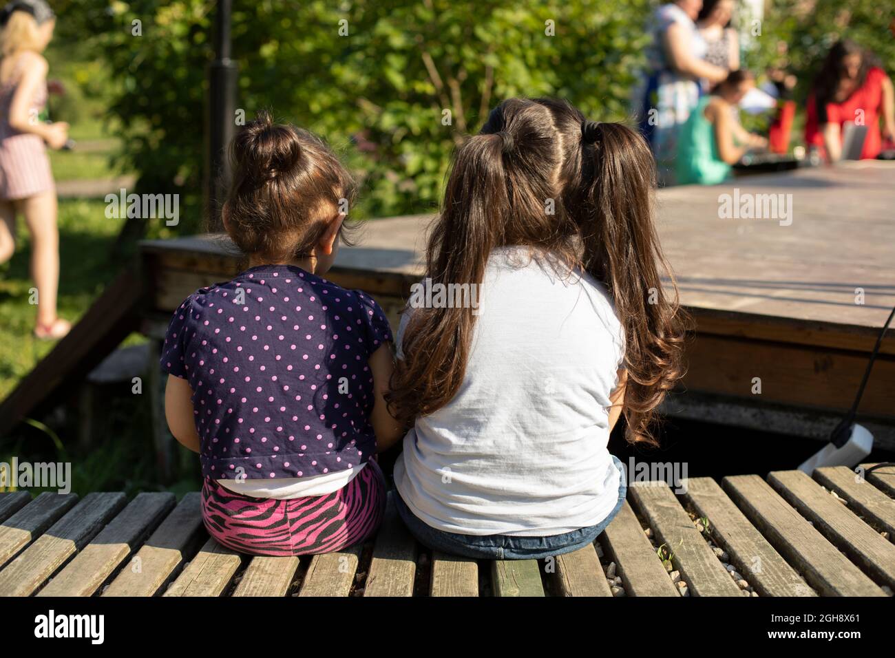 Children sit outside in the summer. Preschoolers in the park. Children ...